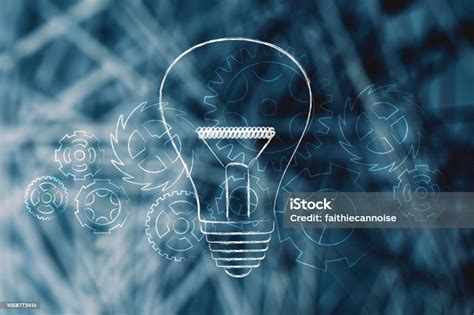 light bulb with gearwheels overlay over unfocused digital network