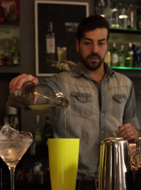 Concentrated Bartender Creating Cocktail By Stocksy Contributor