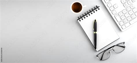 Top View Of Modern White Office Desk With Computer Keyboard Blank Notebook Page And Other