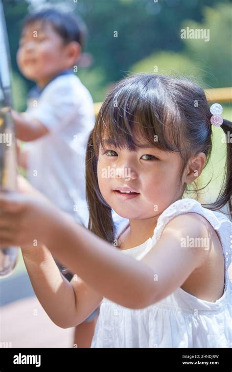 Japanese Siblings Playing On The Playground Equipment Stock Photo Alamy