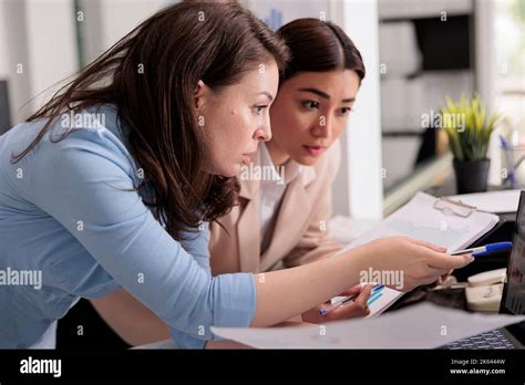 Colleagues Analyzing Financial Report Statistics On Laptop Checking Data Unicorn Business