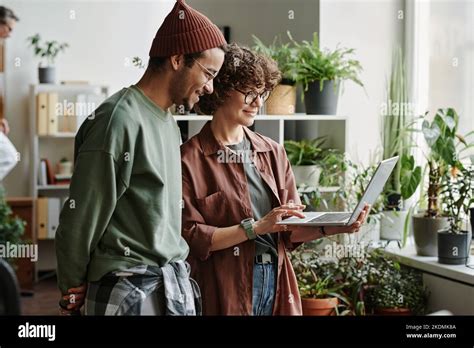 Two Young Software Developers Discussing Online Information And Their