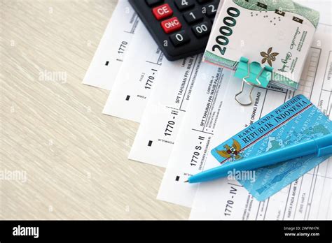 Annual Individual Income Tax Return Forms With Pen And Indonesian Rupiah Bills Original Name Is
