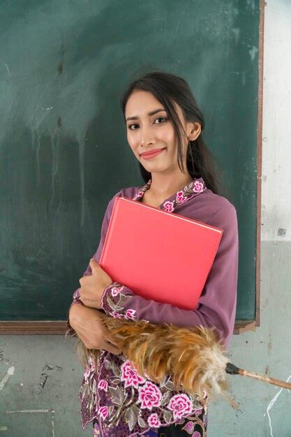 Premium Photo Portrait Of Smiling Teacher Standing Against Blackboard