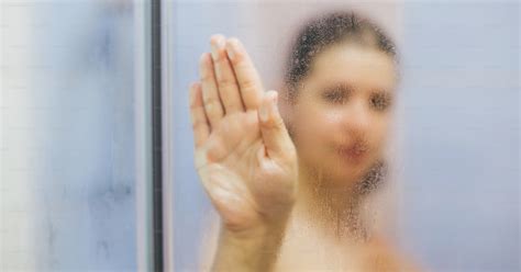 Young Happy Woman Taking Hot Shower At Home Or Hotel Bathroom