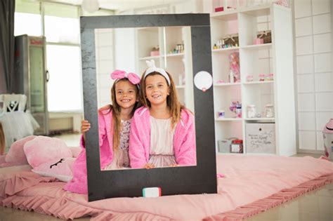 침대에 앉아 프레임을 들고 있는 두 명의 어린 소녀 카메라를 보고 2명에 대한 스톡 사진 및 기타 이미지 2명 6 7 살 8 9 살 Istock