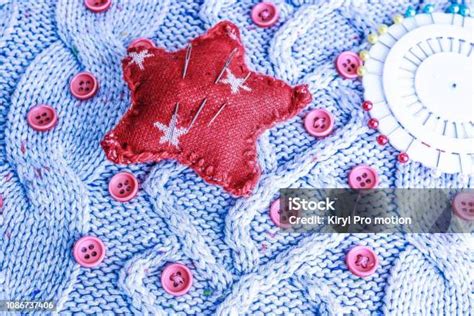 부드러운 따뜻한 자연 스웨터 니트 직물 및 작은 빨강의 아름 다운 질감 바느질 및 바늘 패드 버튼 라운드 플랫이 하다 배경