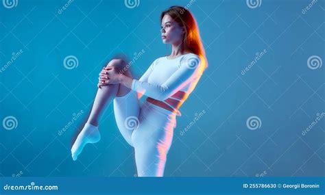 Athletic Slim Girl Exercises Stretching Hip Muscles Raising Leg