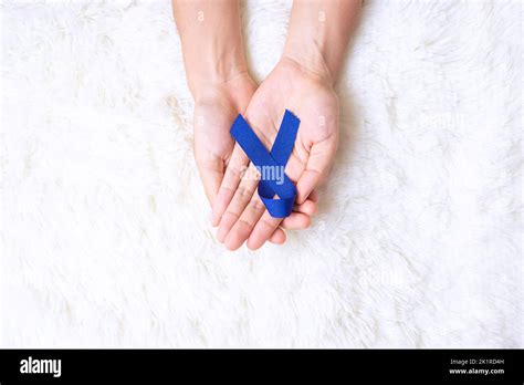 March Colorectal Cancer Awareness Month Man Holding Dark Blue Ribbon