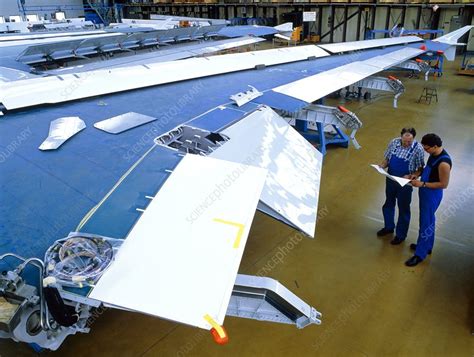 Technicians Assembling Part Of An Aircrafts Wing Stock Image T612