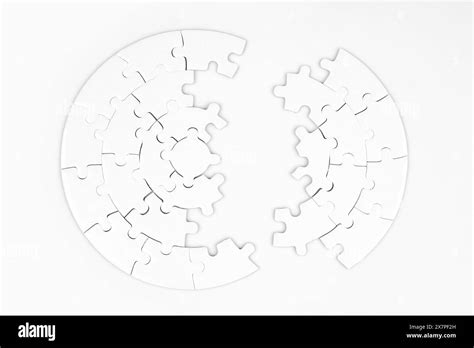 close up top view of a blank circular jigsaw puzzle split into two parts on white background