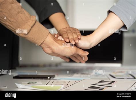 collaborative teamwork in ux ui design process with hands stacked over