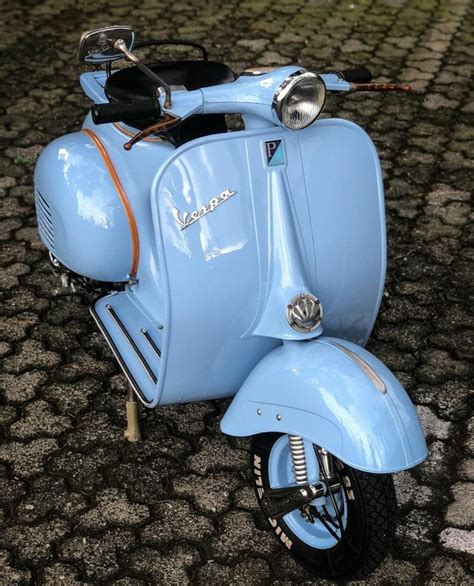 Blue Vespa Scooter On Cobblestone