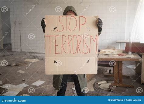 Stop Terrorism Card In Female Hands Who Standing In Abandoned Building