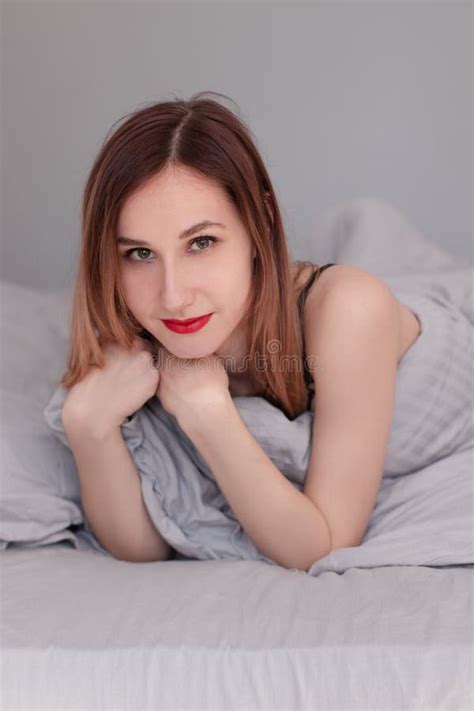 Pretty Redhead Woman In Black Lace Lingerie On Bed With Grey Sheets Stock Photo Image Of