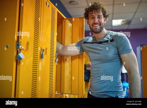 Cheerful Young Man Standing In Gym Locker Room Getting Ready For