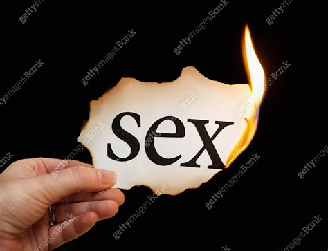 Burning Piece Of Paper Labelled Sex Held By Female Hand 이미지