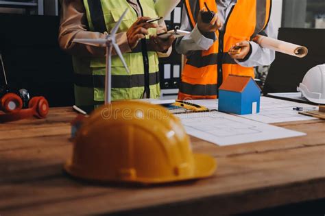 Engineers Are Helping To Design Work On Blueprints And Collaborate On Structural Analyzing Of