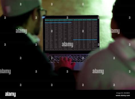 Back View Of Two Diverse Male Colleagues Using Laptop With Coding On Screen Coding Programming