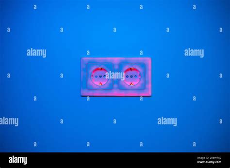 Red Illuminated Socket To Symbolise Power Consumption And Electrical Energy From A Socket Outlet