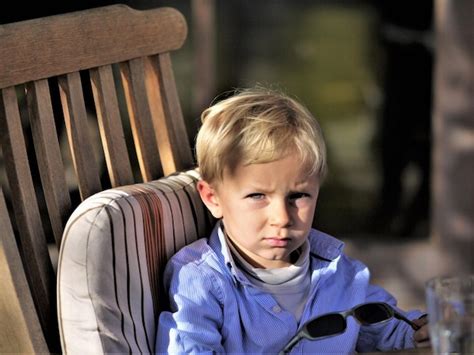 Premium Photo Portrait Of Boy Sitting On Chair