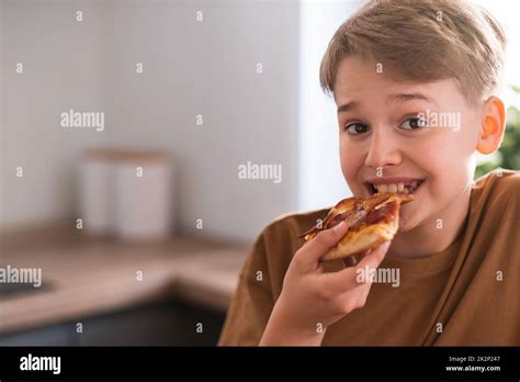 Happy Teenager Enjoying Eating Delicious Pizza At Home Freshly Baked