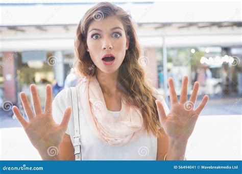Portrait Of Astonished Woman Touching Window With Both Hands Stock