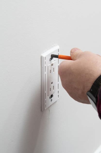 Premium Photo An Electrician Installs New Current Socket