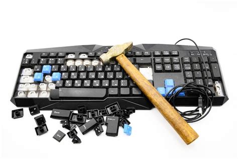 Premium Photo A Broken Keyboard Smashed With An Iron Hammer Lies On A White Background