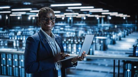 data center female programmer using laptop computer smiling and