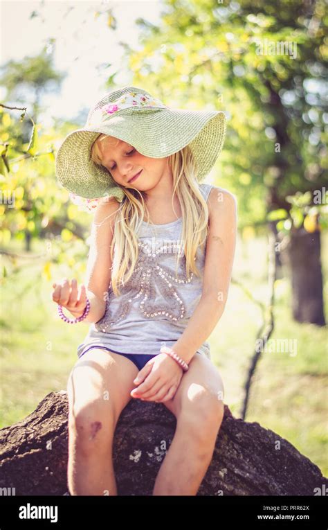 Adorable Innocent Girl Portrait In Hat In Head In Sunny Day In The