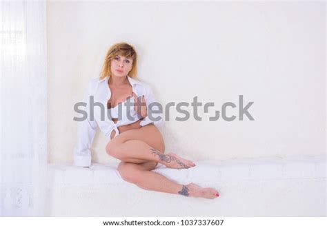 Sexy Fit Mature Woman In White Lingerie At White Interior Concept Of