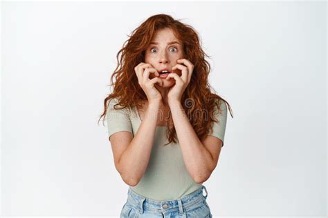 Image Of Overwhelmed Ginger Girl Staring In Panic Screaming Anxious And Biting Fingernails