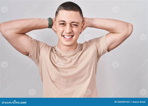 Young Man Standing Over Isolated Background Relaxing And Stretching