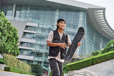 젊 은 남성 은 손 에 스 케 이 트 보드 를 든다 사진 무료 다운로드 Lovepik