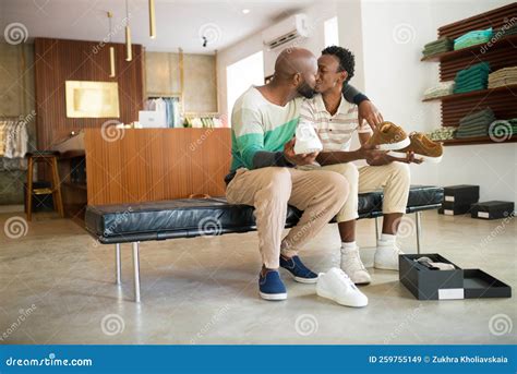 Portrait Of Happy African Gay Couple Kissing On Bench In Shop Stock Image Image Of Young
