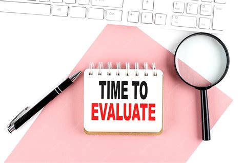 Premium Photo Business Concept Notebook With Text Time To Evaluate On Pink Paper With