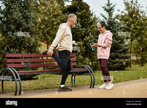 A Loving Couple Engages In Playful Stretching Exercises While Smiling