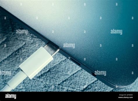 Connecting The USB Type C Wire Close Up In The Case Of A Gray Laptop With Brushed Aluminum Stock