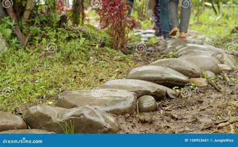 Barefoot Legs Walking On A Rocks Somewhere In A Tropical Amazon