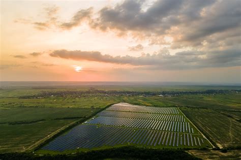 저녁에 청정 생태 전기 에너지를 생산하기위한 태양 광 발전 패널의 많은 행과 대형 지속 가능한 전기 발전소의 공중 보기 제로 배출 개념재생 전기 무배출에 대한 스톡 사진 및