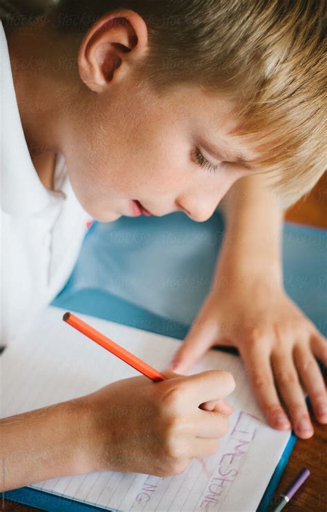 A Tween Boy Doing School Work By Stocksy Contributor Helen Rushbrook