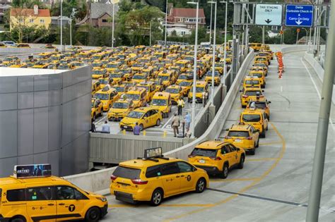 Rows Of Yellow Taxi Cabs Wait To Pick Up Passengers At New Yorks