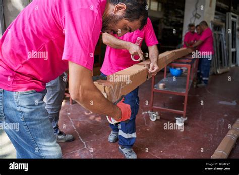 Workers Packing Cardboard Box In Warehouse For Shipment An Operator