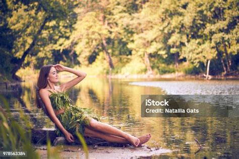 여름 더위입니다 고 사리 잎에서 오픈 옷 숲의 호수에 아름 다운 젊은 여자는 완벽 하 게 자연과 함께 결합 환상 요정 Dryads 캐릭터의 코스 프레의 형태로 사람 귀여운에