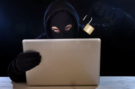 Dangerous Hacker Man With Computer And Lock Hacking System In Cyber Crime Concept Stock Image