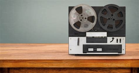 빈티지 회색 그라데이션 배경이 있는 테이블에 있는 오래된 복고풍 영화 플레이어 사진 Unsplash의 오디오 카세트 이미지
