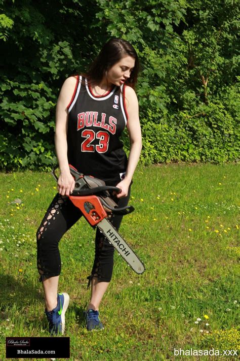 Solo Hottie Loves Posing With A Chainsaw Outdoors Photos