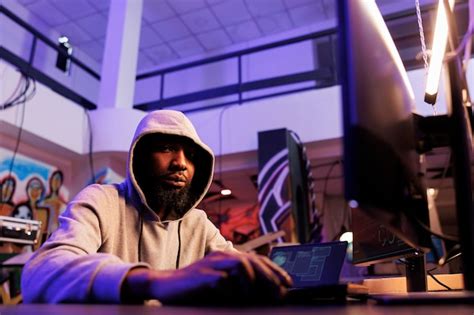 premium photo hacker coding internet virus malicious software on computer portrait african