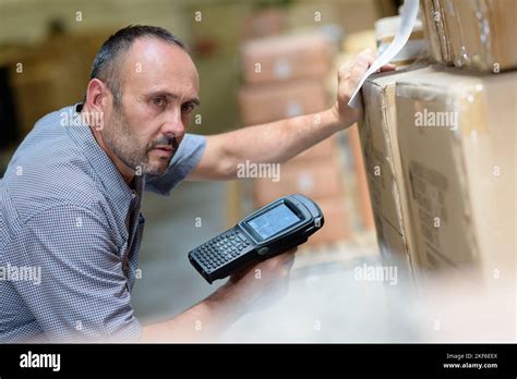 Worker In Charge Of Scanning Boxes With Problematic Expression Stock